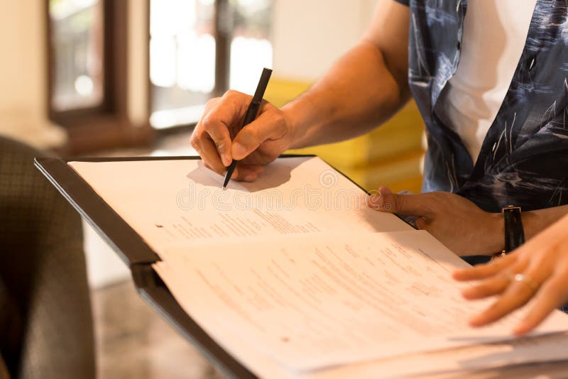 Mans Hand Signing Agreement from Stock Photo - Image of hotel, flowers ...