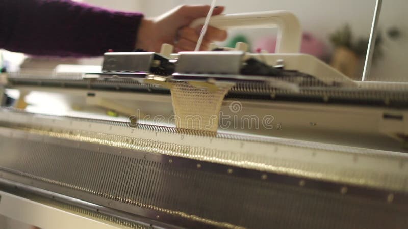 Young Woman Knitting Textile on Weaving Machine Sitting at Table in ...