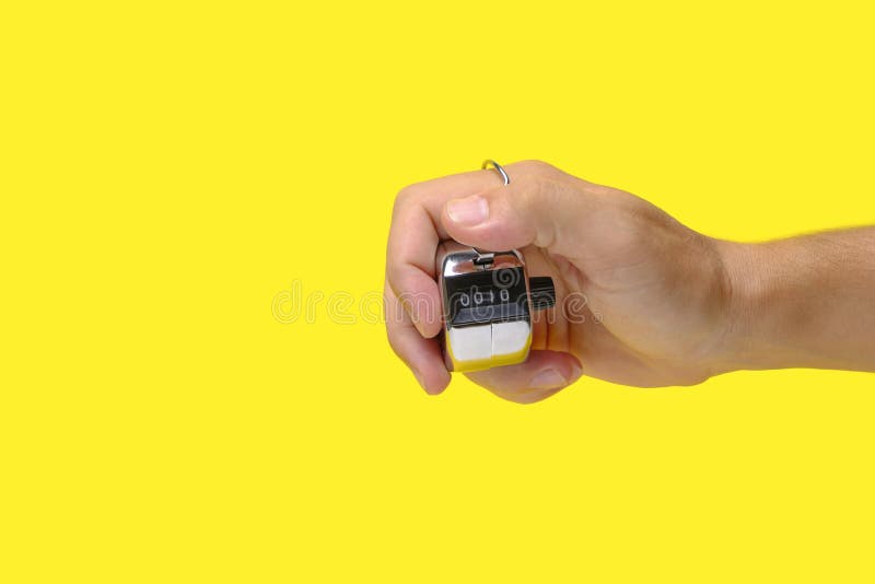 Manual Mechanical Counter in Hand on Yellow Background. Stock Image ...