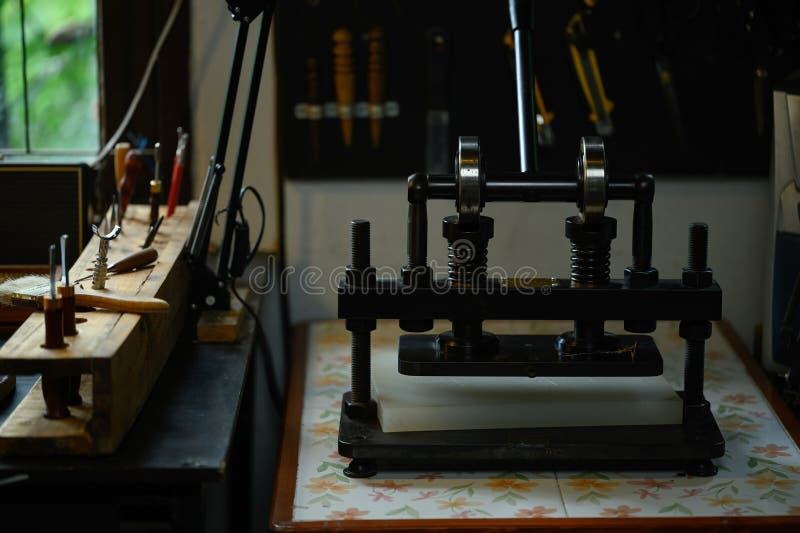 Manual Press Machine and Various Leather Craft Tools on Wooden Table in ...