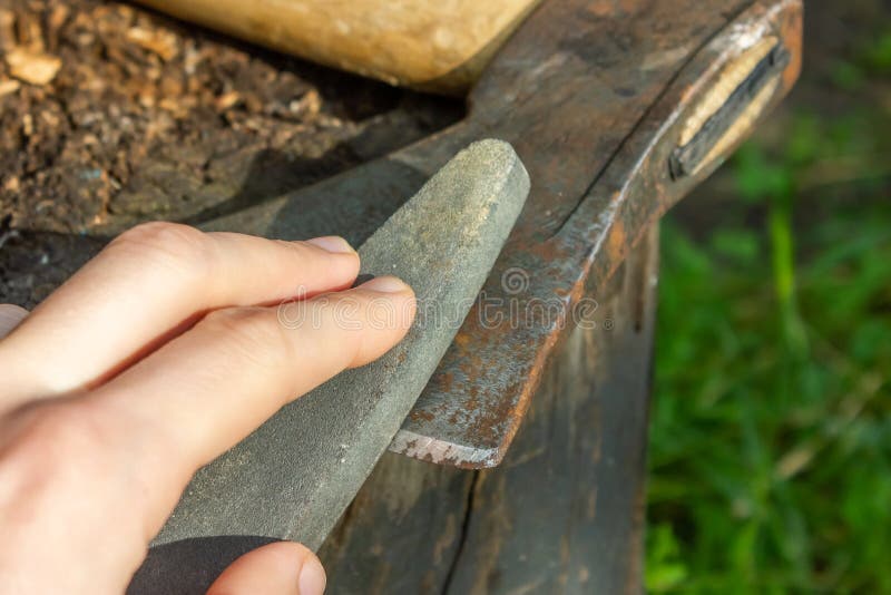 Manual Sharpening of an Axe. Grinding Stone in the Hands of the Master ...