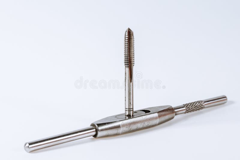 Manual Tap for Cutting Threads in Metal on a White Background. Metal ...