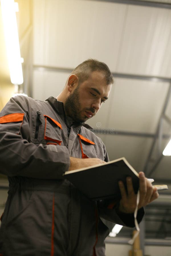 Helicopter Pilot Reading a Manual Book Stock Photo - Image of helipad ...
