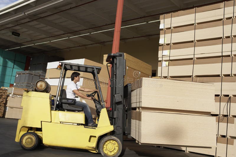 Man Operating Forklift Truck in Warehouse Stock Photo - Image of loader ...