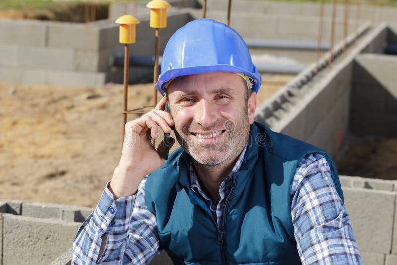 Manual Worker Using Phone in Construction Site Stock Image - Image of ...