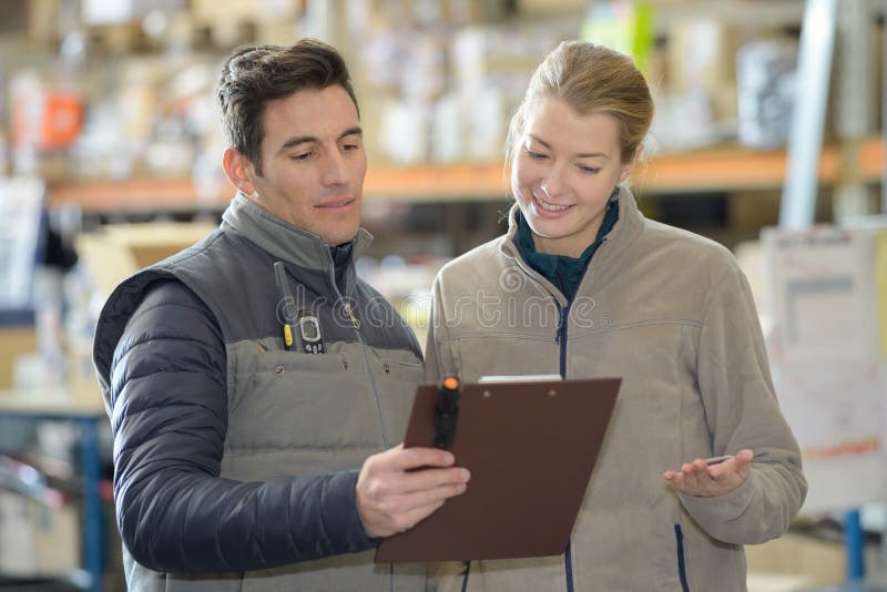 Manual Workers Checking Package in Clipboard Stock Photo - Image of ...