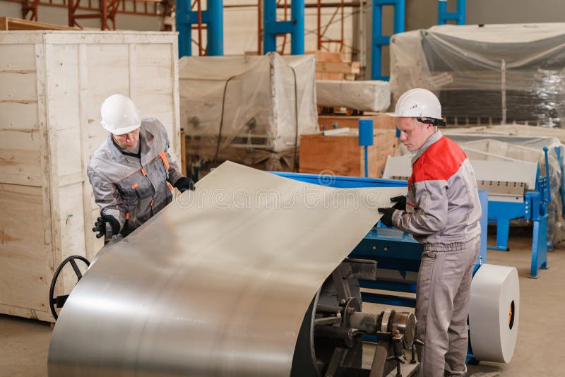Manufacture Workshop. Workers Adjusts the Machine in the Warehouse. the ...