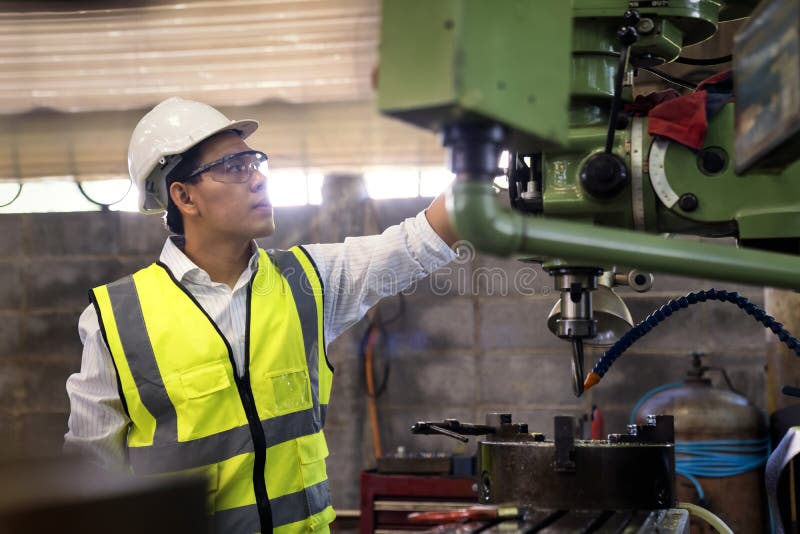 Manufacturing Worker. Asian Mechanical Engineer Operating Industrial ...