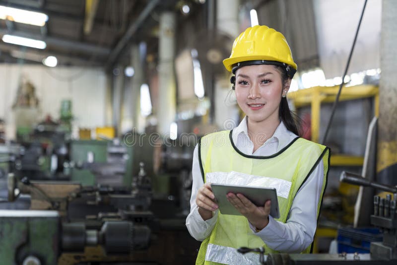 Manufacturing Worker Using Computer Tablet at Work. Asian Worker ...