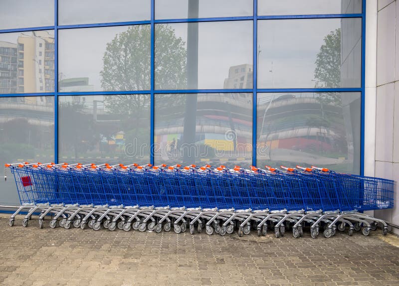 Many Aligned Shopping Carts at the Hypermarket Stock Image - Image of ...