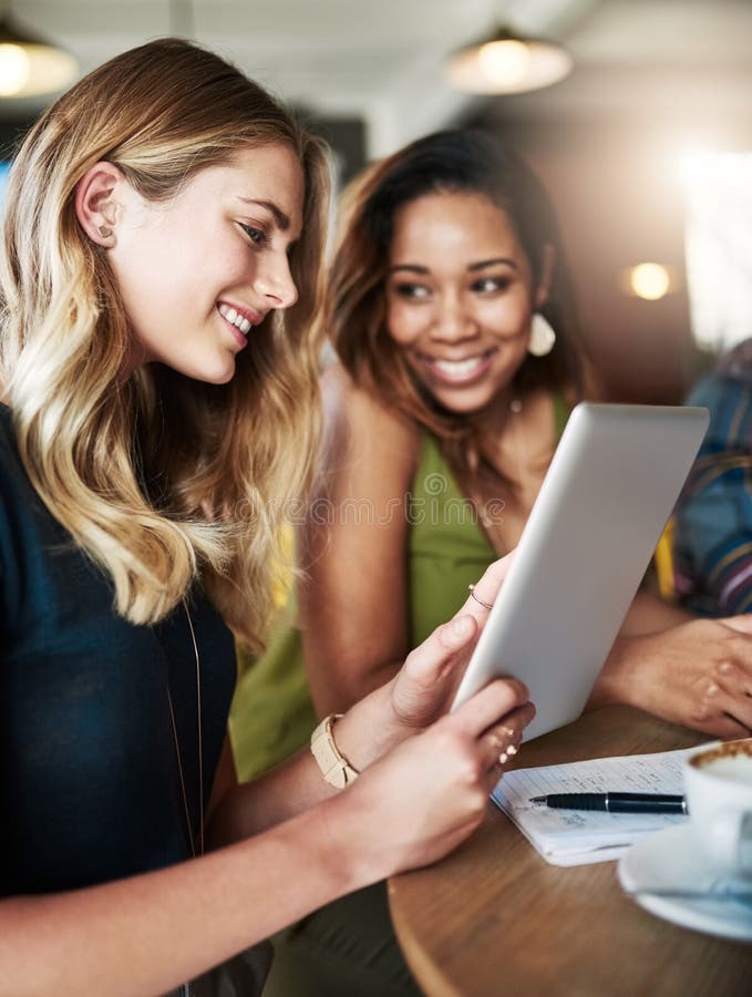 So Many Apps To Choose from. Two Friends Using a Tablet while Having ...