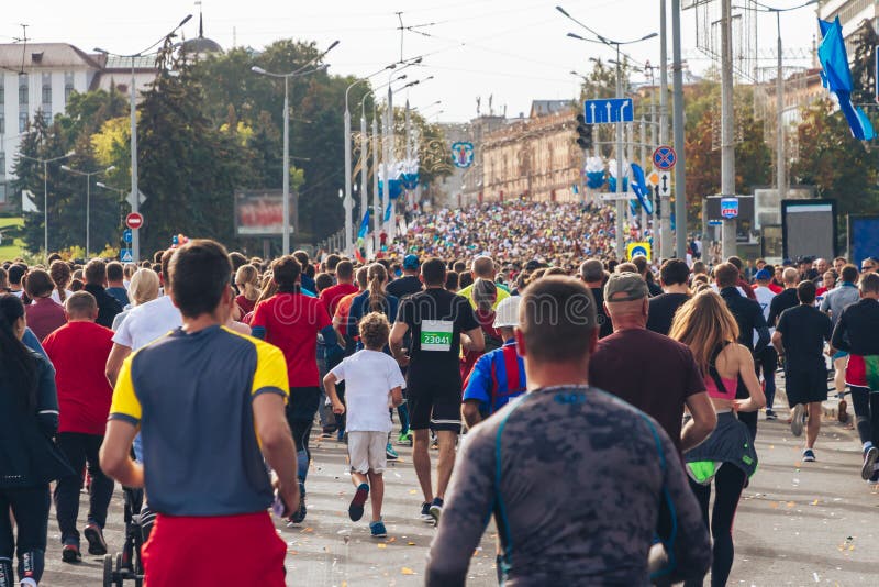 Many Athletes Run a Marathon on a City Road. Editorial Image - Image of ...