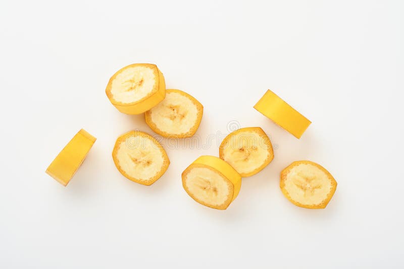 Many Banana Slices In Peel Falling, Isolated On White Background. Top ... Many Banana Slices In Peel Falling, Isolated On White Background. Top ...