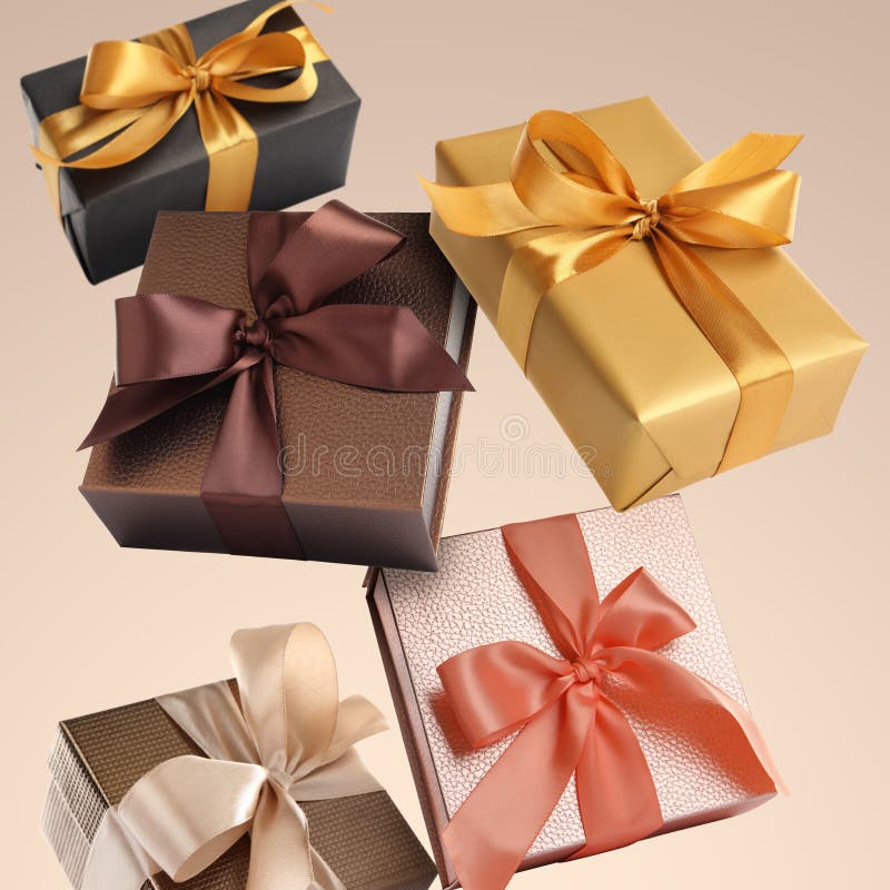 Many Beautiful Gift Boxes Falling on Beige Background Stock Image ...