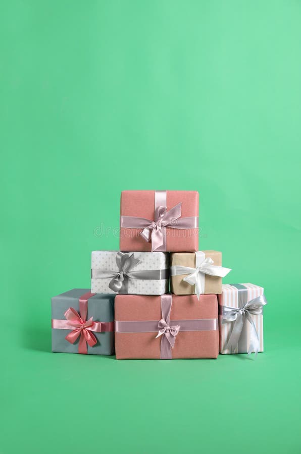 Many Beautifully Wrapped Gift Boxes on Green Background Stock Photo ...