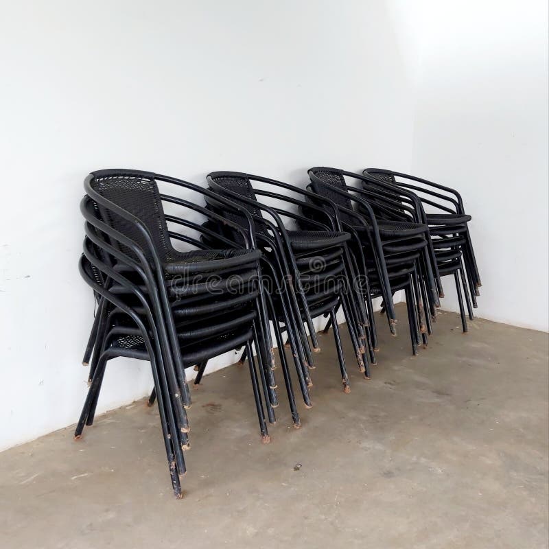 Many black chairs stacked stock image. Image of black - 210199765