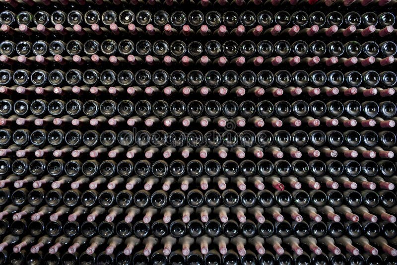 Many Bottles in a Row Stacked on a Winery Shelf Stock Photo - Image of ...