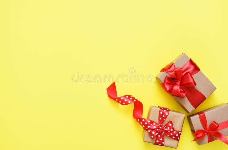 Many Boxes with Gifts and Red Ribbons on a Yellow Background. View from ...
