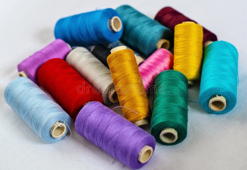 Many Bright Color Thread Spools on White Fabric - Image Stock Photo ...