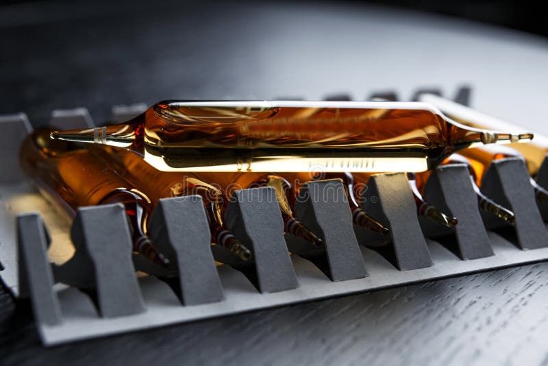 Many Brown Ampoules Set in Pharmaceutical Packaging White Container ...