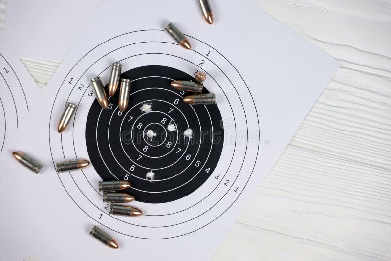 Many Bullets on Shooting Targets on White Table in Shooting Range ...