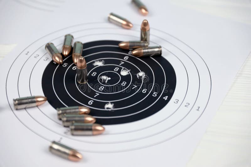 Many Bullets on Shooting Targets on White Table in Shooting Range ...