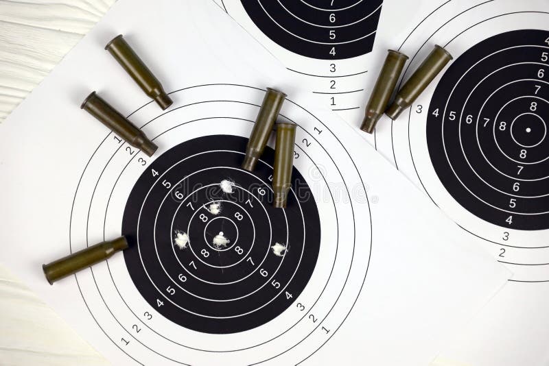 Gun and Many Bullets Shooting Targets on White Table in Shooting Range ...