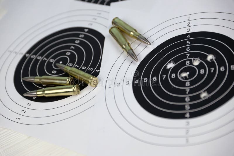 Many Bullets on Shooting Targets on White Table in Shooting Range ...