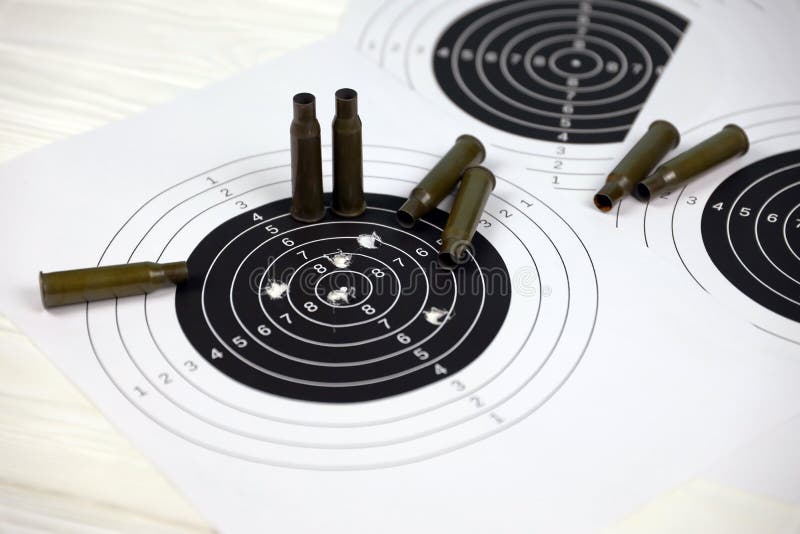Gun and Many Bullets Shooting Targets on White Table in Shooting Range ...