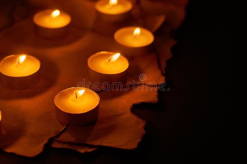 Many Burning Circle Candles and Ancient Burnt Paper Sheets Stock Photo ...