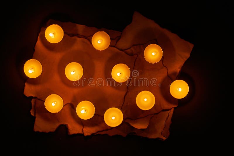Many Burning Circle Candles and Ancient Burnt Paper Sheets Stock Image ...