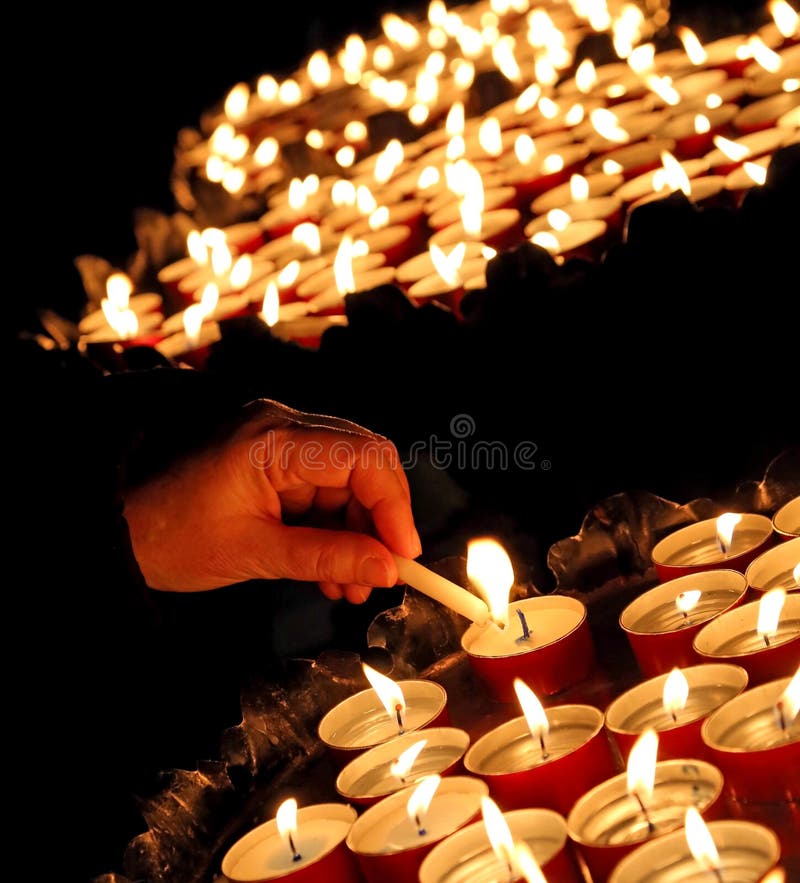 Many Candles Lit in the Church and the Hand of the Lady Stock Image ...