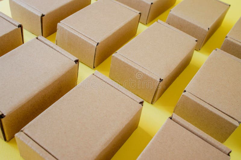 Many Cardboard Kraft Boxes on a Yellow Background. Packing the Parcel ...