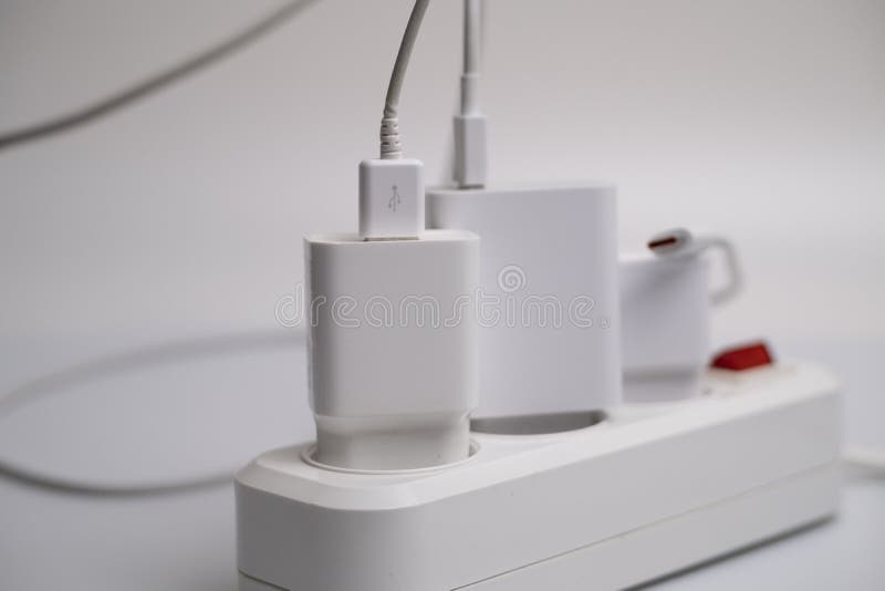 Many Chargers are Connected To an Electrical Outlet on a White ...