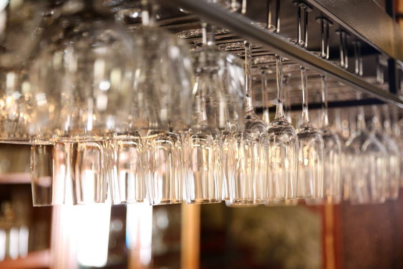 Many Clean Glasses on Metal Rack Stock Photo - Image of elegant, glass ...