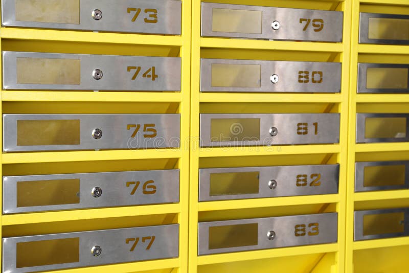 Many Closed Metal Mailboxes with Keyholes and Numbers As Background ...