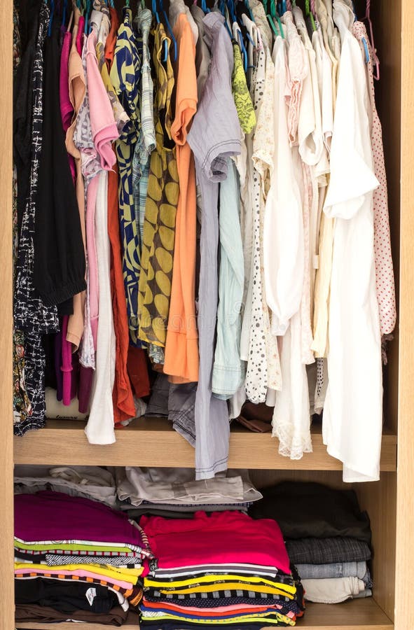 Many Colorful Clothes in Wardrobe Stock Photo - Image of fabric, female ...
