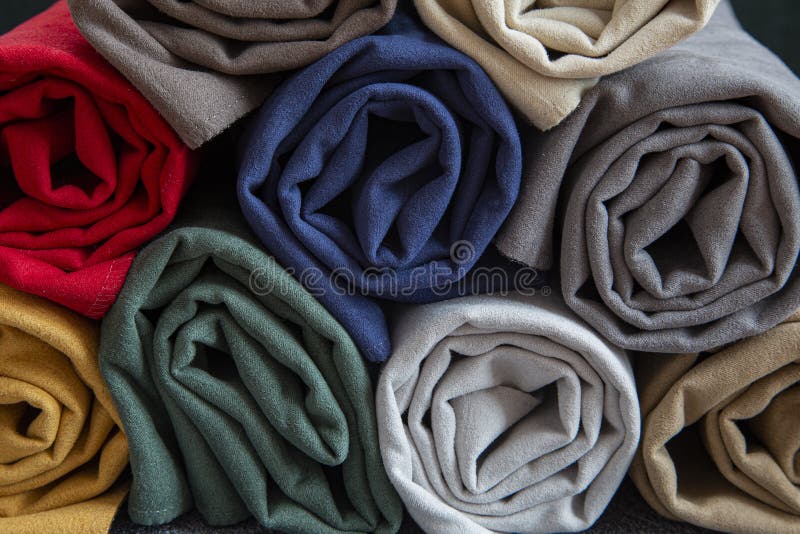 Many Colorful Rolls of Fabric on a Plain Background Stock Photo - Image ...