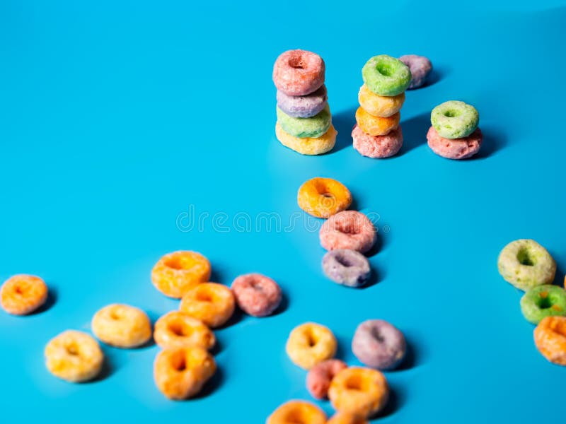 Many Colorful Sugary Cereal Grains on a Blue Background Stock Photo ...