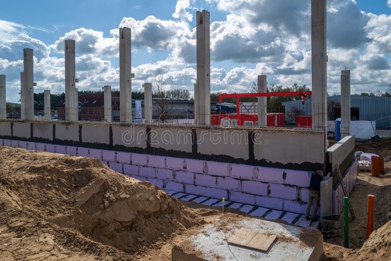 Concrete Pillars for a Factory Building are Erected on a Construction ...