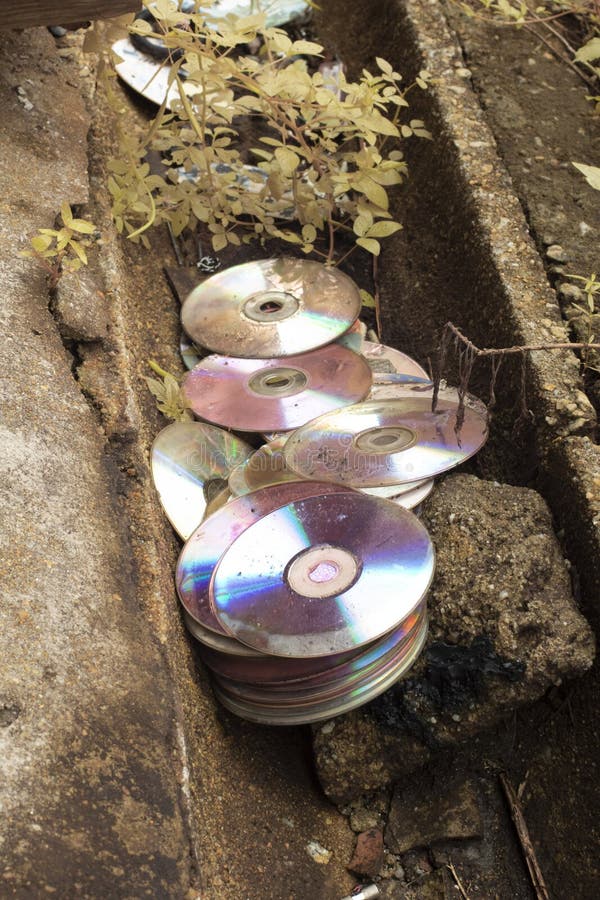 The Many Copies of Trash and Dirty Compact Disc in the Drain Stock ...