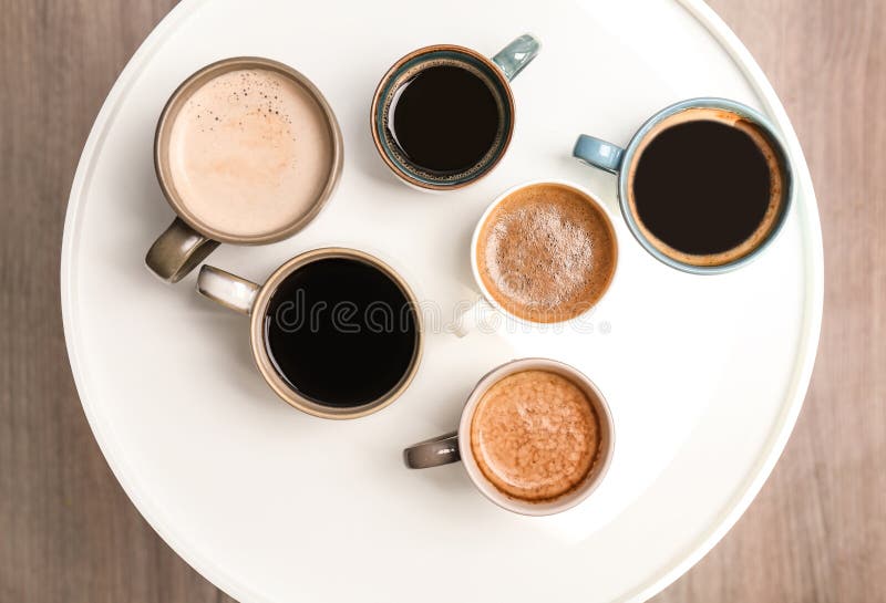 Many Cups of Different Aromatic Hot Coffee on Table Stock Image - Image ...