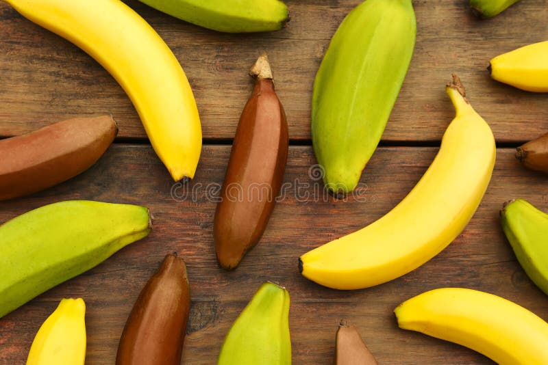 Many Different Bananas on Wooden Table, Flat Lay Stock Photo - Image of ...