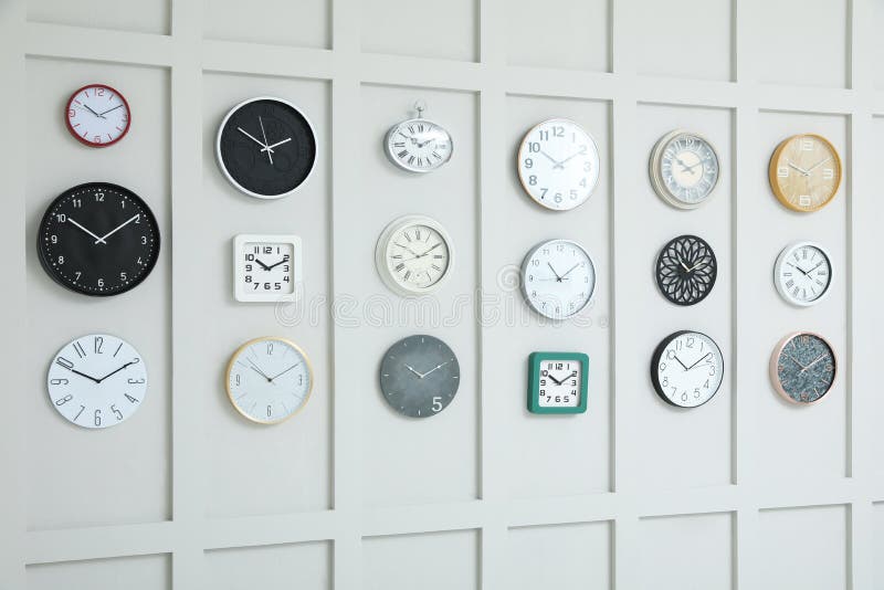 Many Different Clocks Hanging on White Wall Stock Image - Image of ...