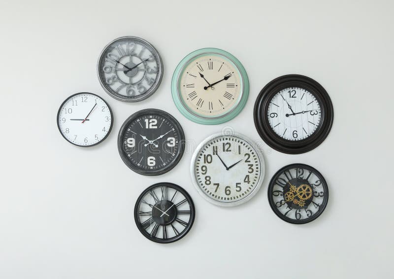 Many Different Clocks Hanging on White Wall Stock Image - Image of ...