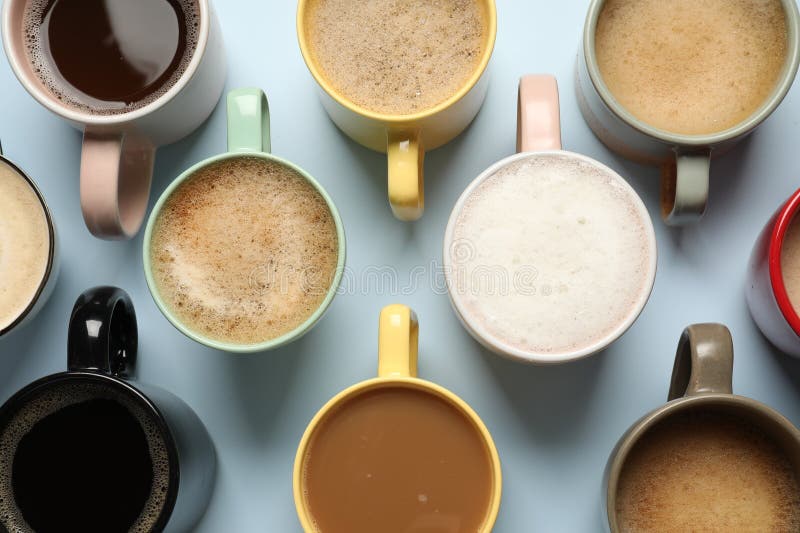Many Different Cups with Aromatic Coffee on Light Blue Table, Flat Lay ...