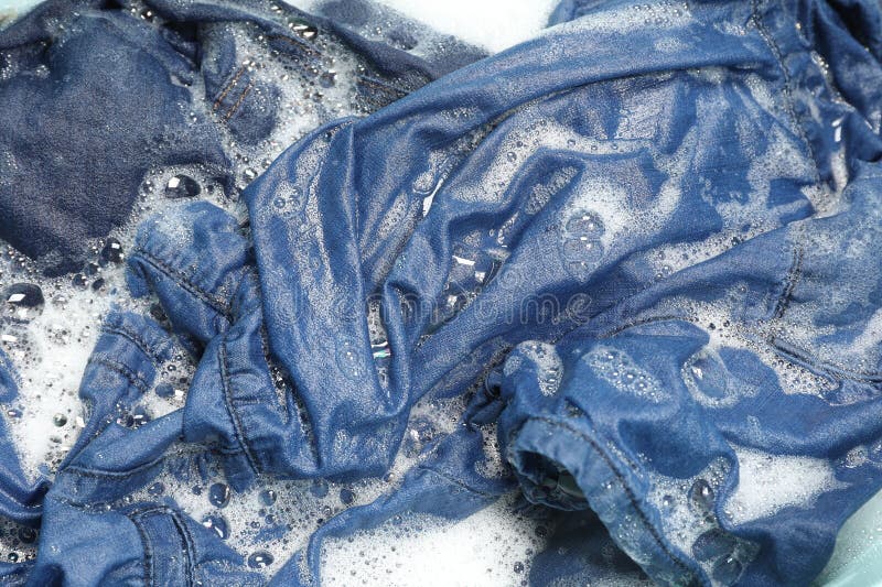 Many Different Denim Clothes in Basin with Water and Soap, Top View ...