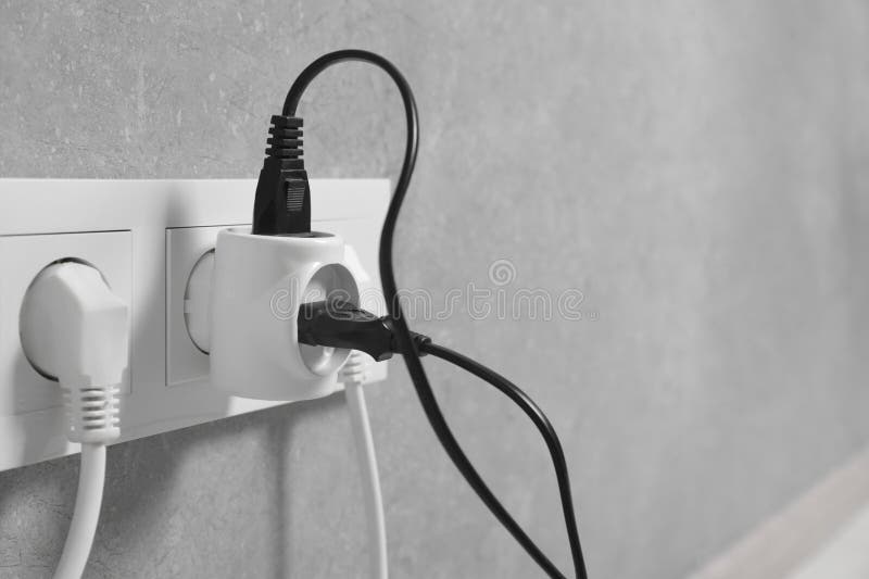 Many Different Electrical Power Plugs in Sockets on Grey Wall Indoors ...