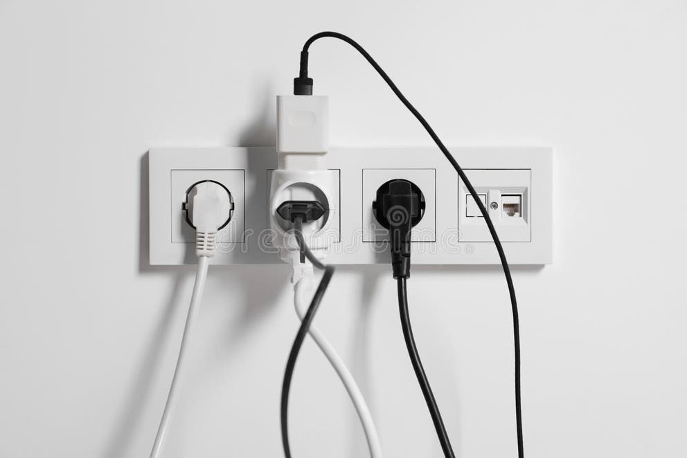 Many Different Electrical Power Plugs in Sockets on Light Wall Stock ...