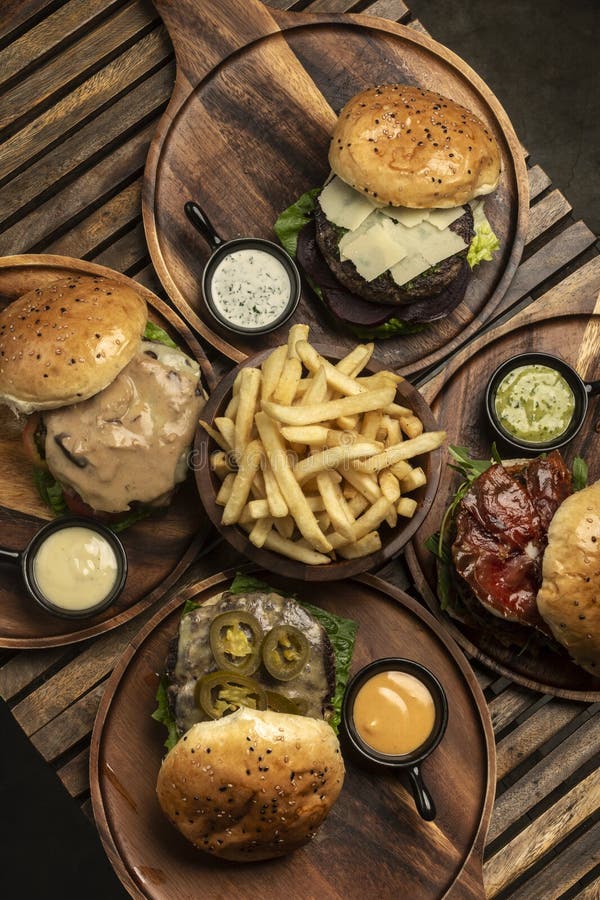 Many Different Gourmet Burgers Selection on Wood Table Stock Photo ...